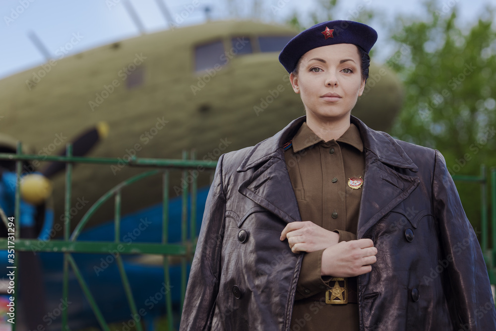 A young female pilot in uniform of Soviet Army pilots during the World ...