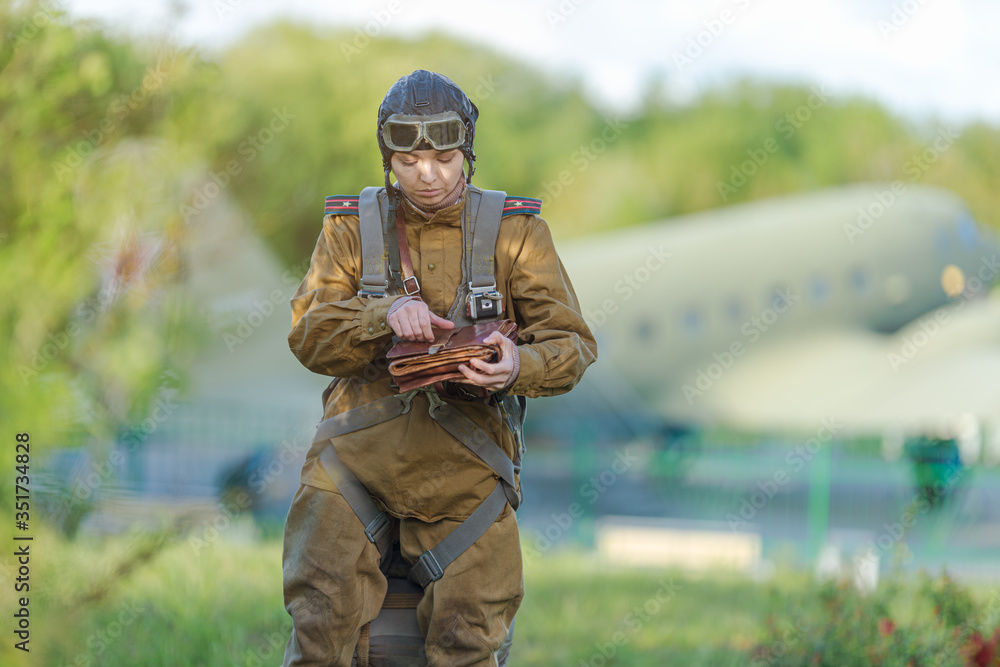 A young female pilot in uniform of Soviet Army pilots during the World ...