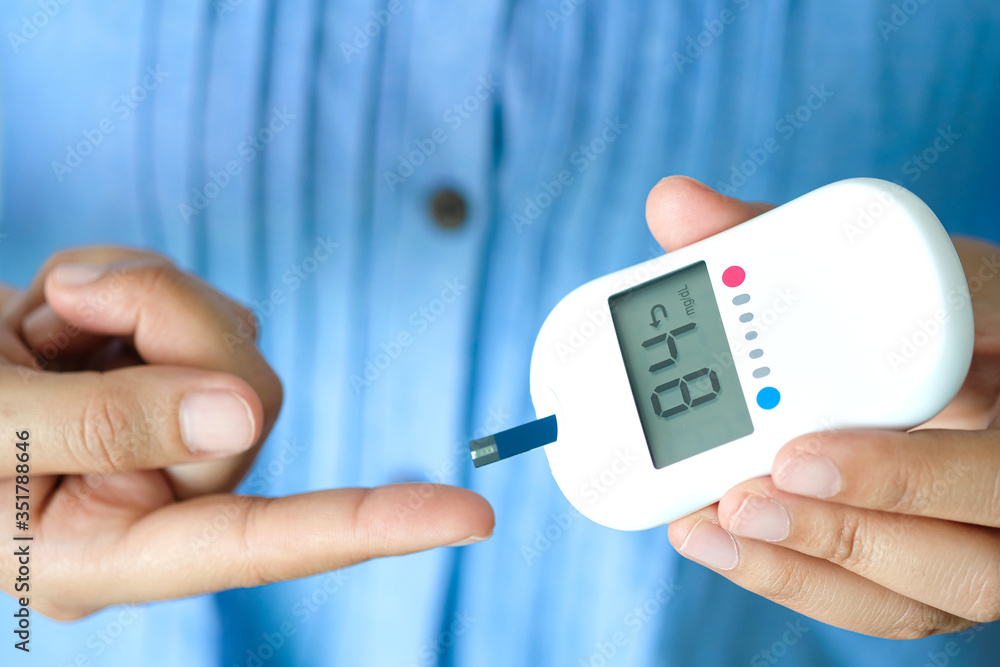hand of people check diabetes and high blood glucose monitor with ...