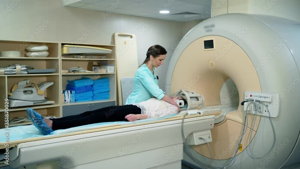 Medical scanning equipment and a female patient. Doctor preparing ...