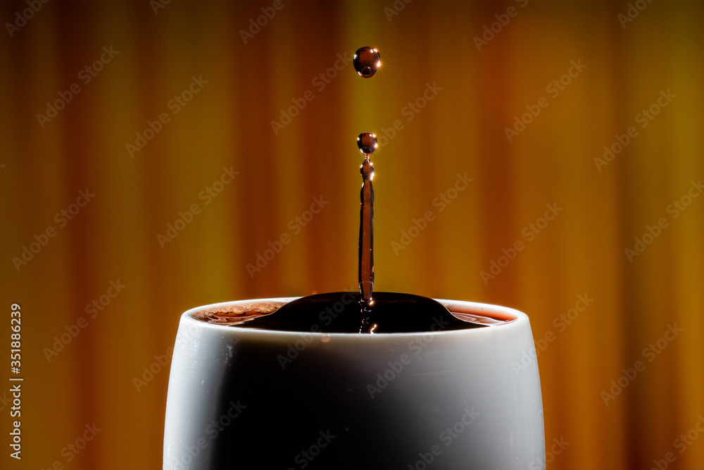 Red wine splash. Reaction of a falling drop on a red wine surface in a ...