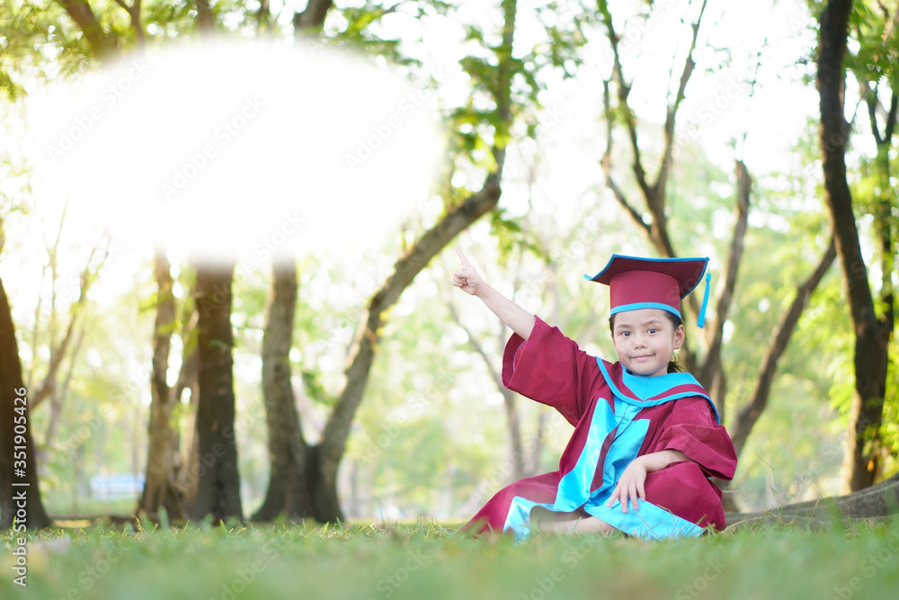 Asian child or kid girl smile and little graduate wear gown degree hat ...
