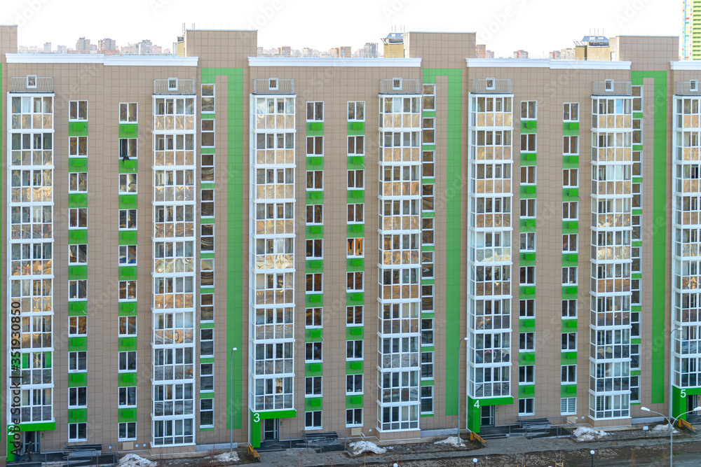 Facade of a tall residential building. High-rise buildings modern ...
