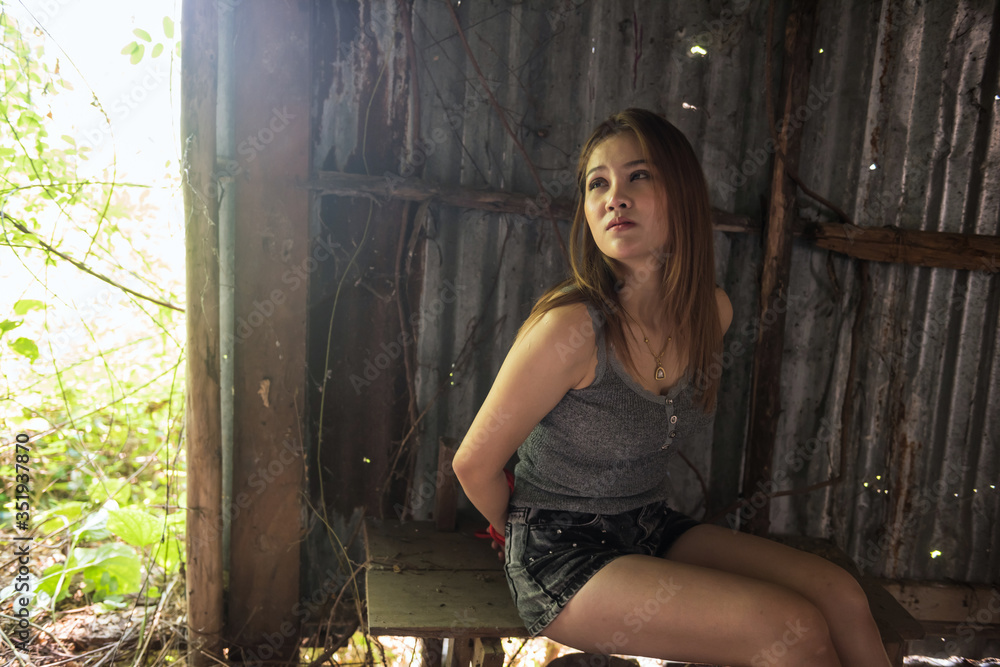 Woman hostage tied by rope in cabin Stock Photo | Adobe Stock