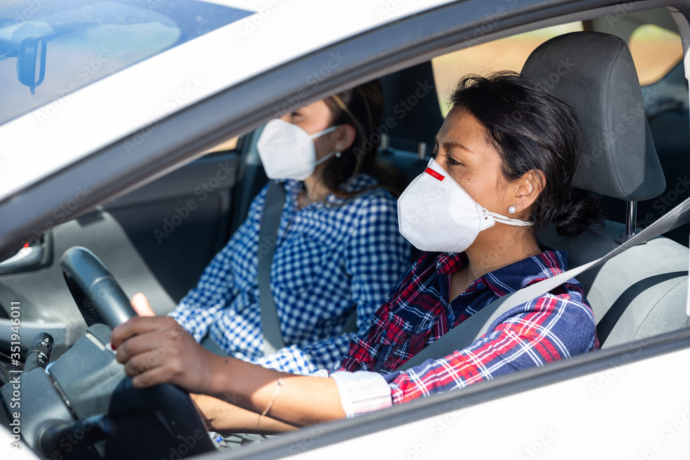Women wearing personal protective equipment while driving a car 스톡 사진 ...