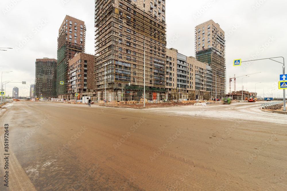 Tall building under construction with scaffolds. Construction site ...
