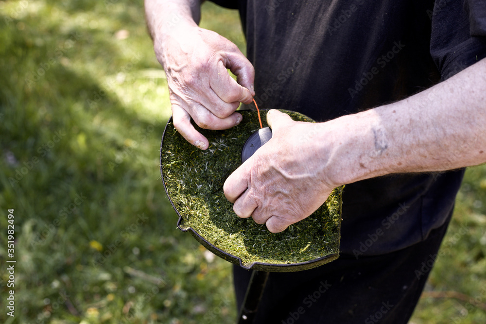 disassembly and installation of the line in the grass trimmer Stock ...