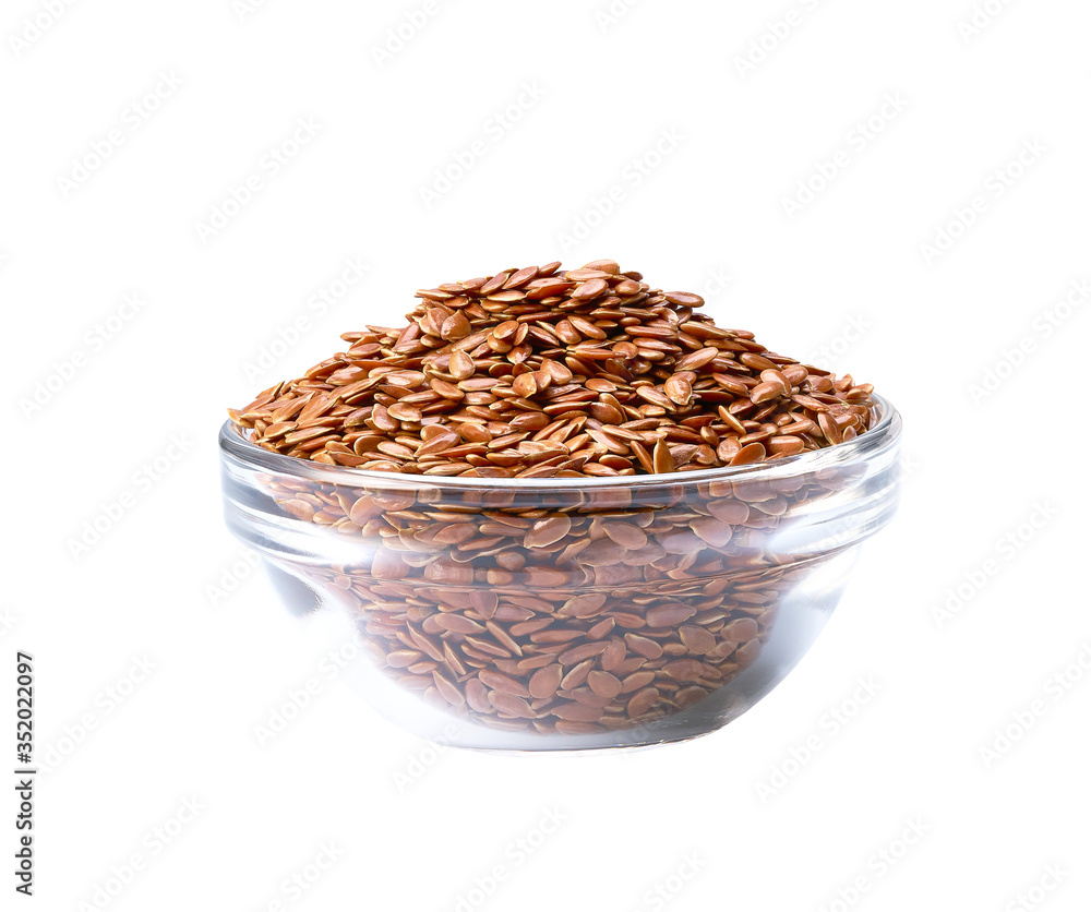 flaxseed in a small transparent glass bowl isolated on a white ...