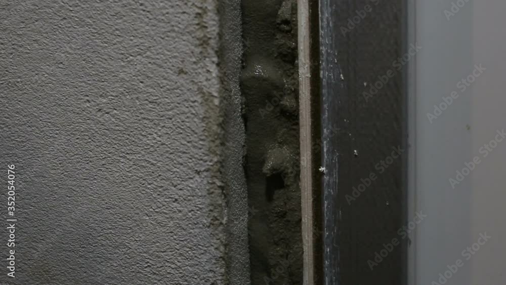 Filling the wall gap with cement mortar from sac a poche, squeezing the ...