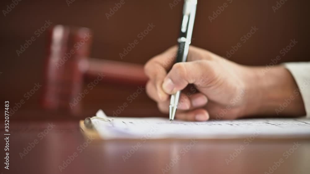 The lawyer is carrying a pen to write a case record in the courtroom ...