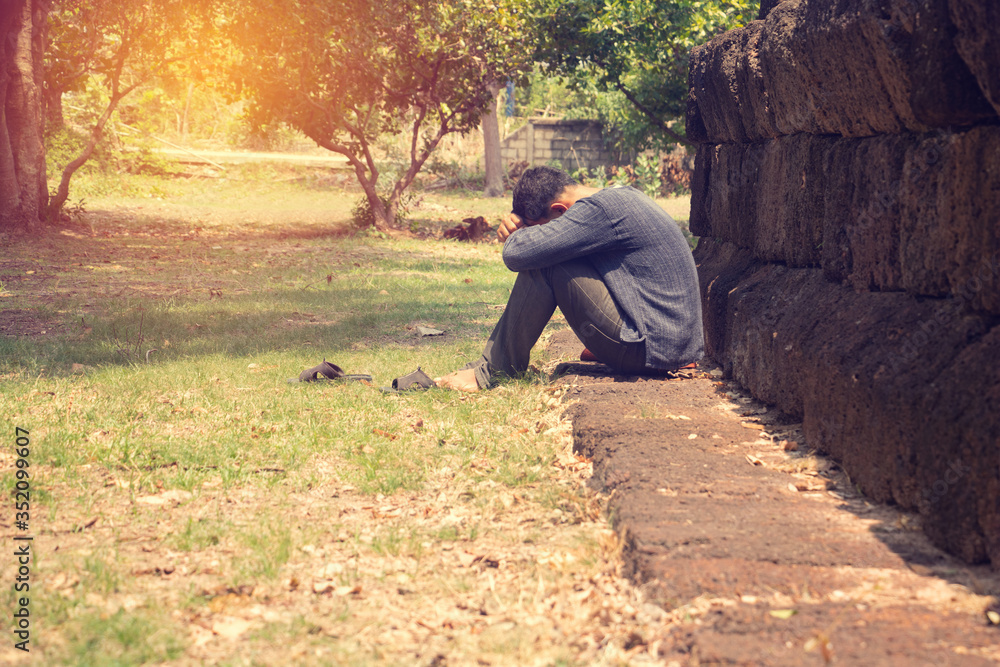 Asia you man sitting alone.He sitting alone beside old wall.man very ...