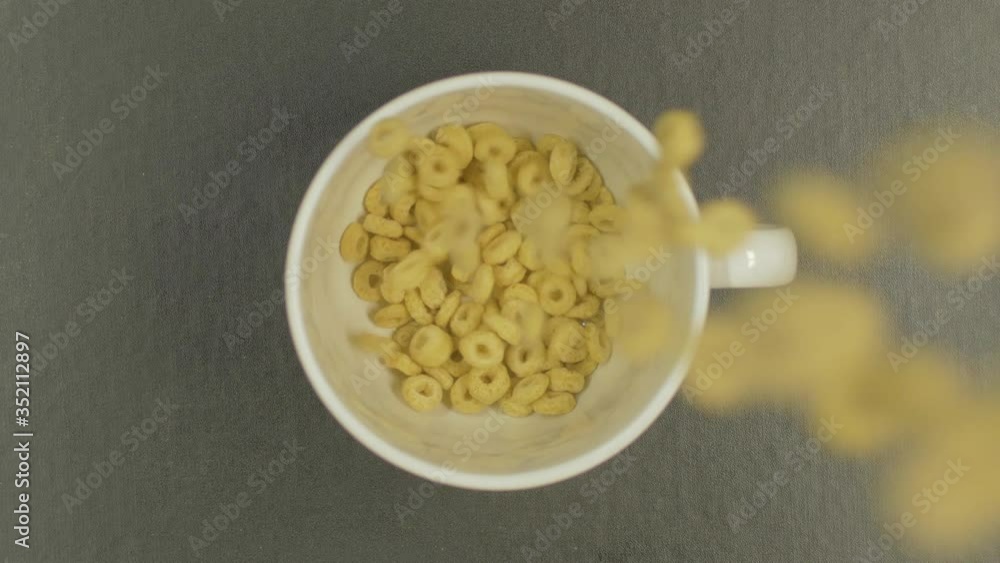 Overhead Top View of cereal rings falling in bowl in slow motion ...