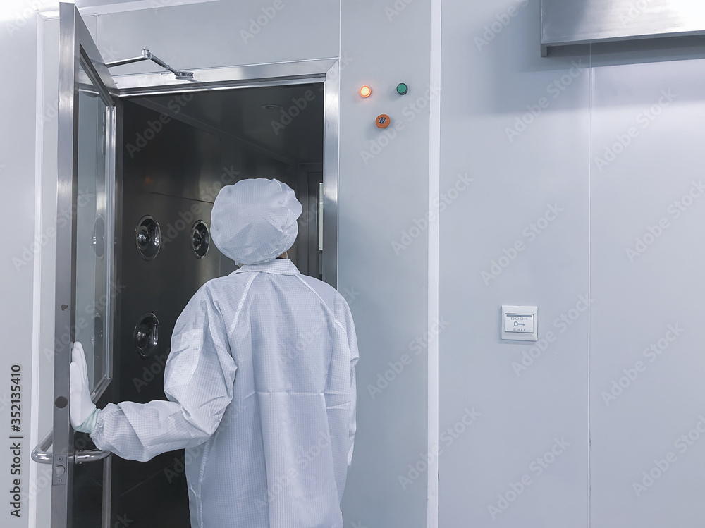 factory worker open the door Air shower for removing dusts before go to ...