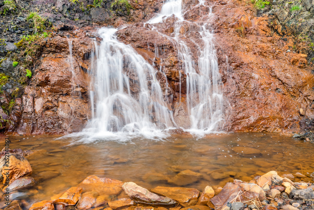 Red rocks and beautiful exotic waterfall cascade at Hvitserkur in ...