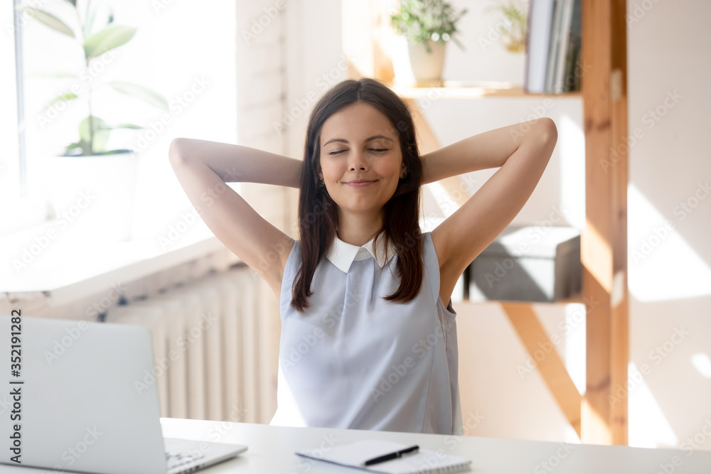 Happy female employee lean in chair relax finishing work in time ...