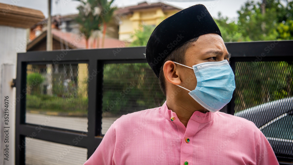 A portrait of young Asian Malay man with Baju Melayu cloth and Songkok ...