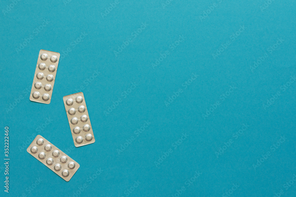 Blister packs with pills on a blue background, lowering blood ...