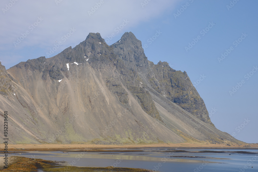Icelands Vestraborn and Brunnhorn mountain rise out of the ocean oand ...