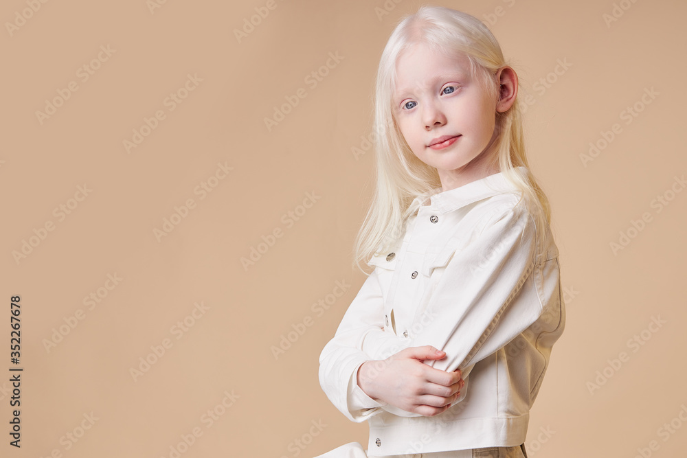 adorable albino girl 7-9 years old posing at camera isolated. shy ...