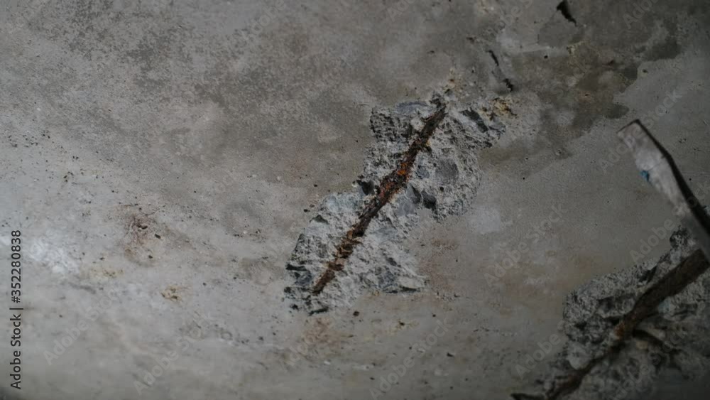 Exposed reinforcement on the crumbling concrete, defect of cement ...