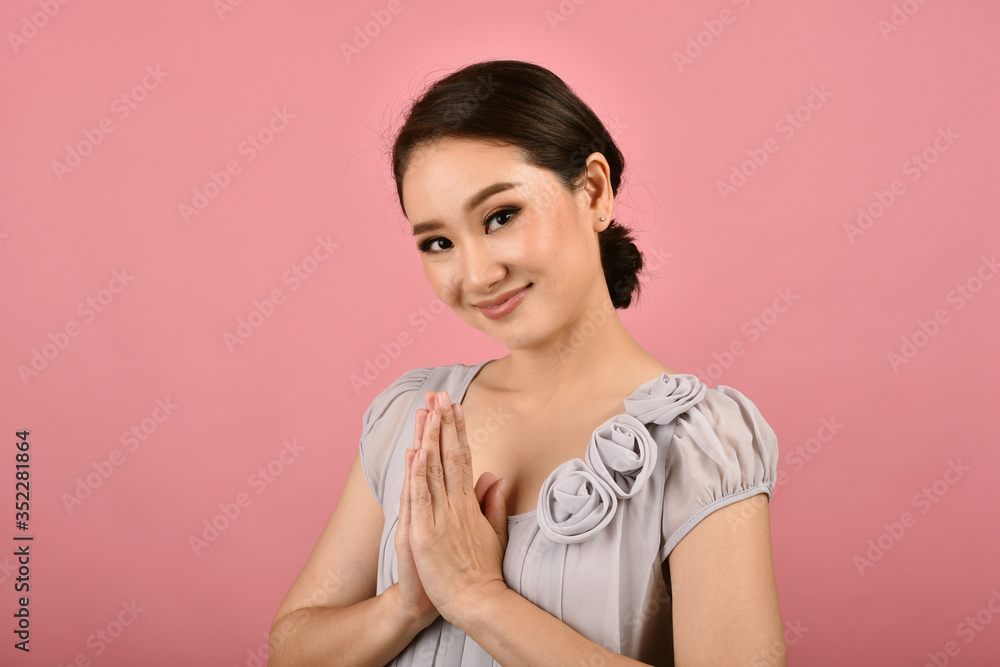 Thai asian smiling woman pay respect with wai sign, Sawasdee symbol is ...