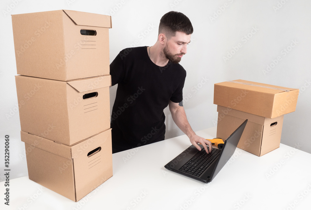 Post office. Sending parcels. Preparing parcels for shipment. A man is ...
