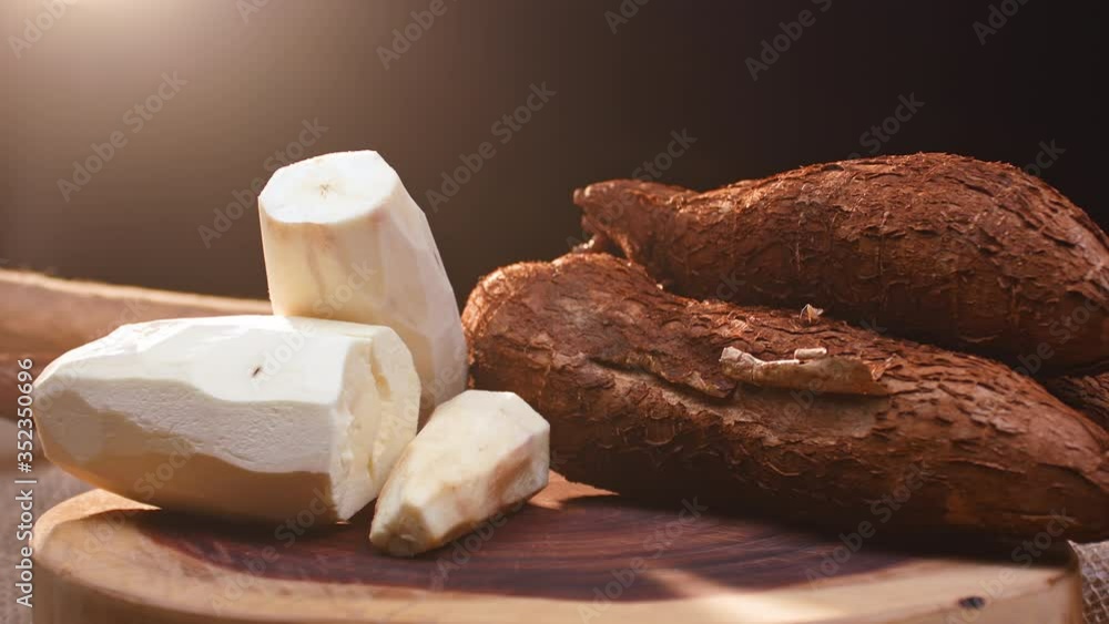 Peeled cassava and cassava in shell on a wooden plank Stock ビデオ | Adobe ...