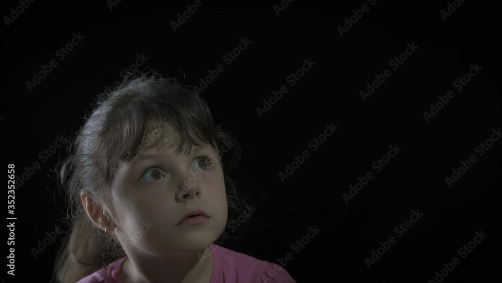 Fear of the child. The little girl hides her face out of fear. Stock ...