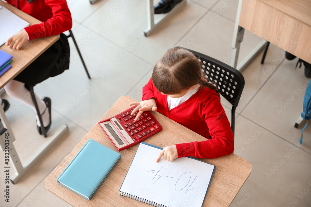 Little girl doing math task in classroom Stock Photo | Adobe Stock