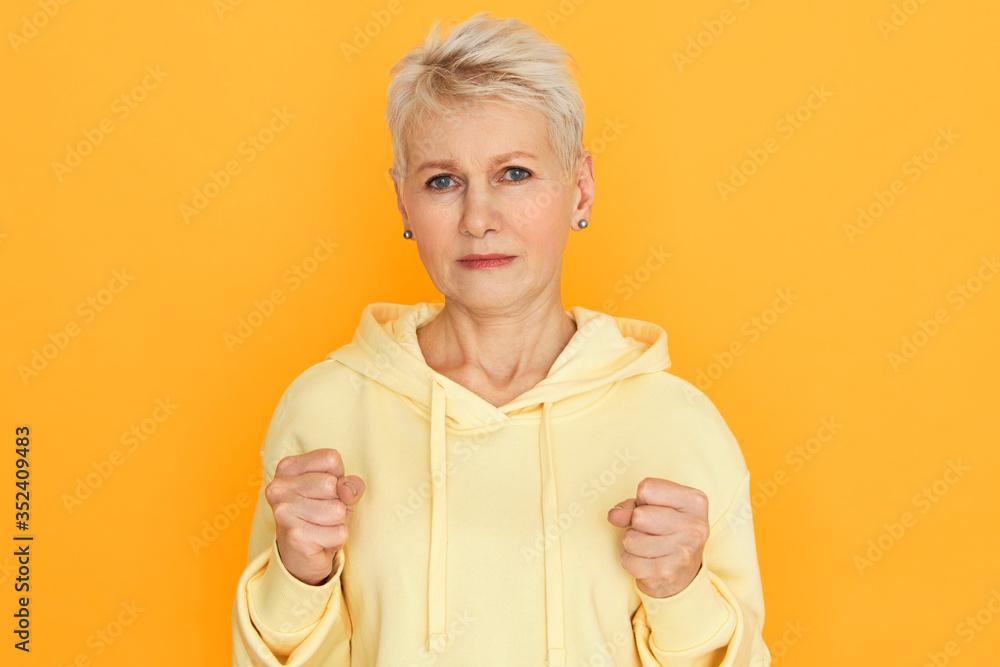 Body language. Isolated image of frustrated upset retired female with ...