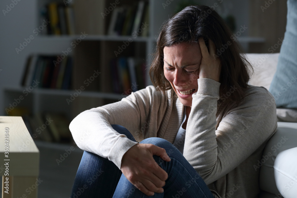 Sad middle age woman crying sitting in the night at home Stock Photo ...