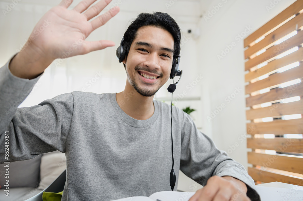 Portrait photo of smart Asian guy using video call communicate with ...