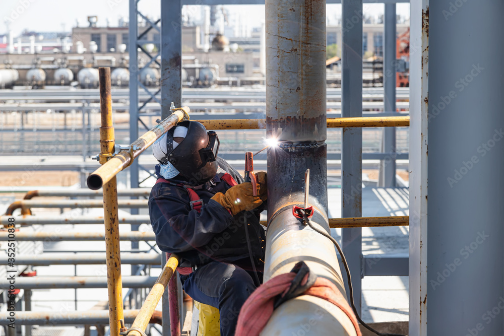 Manual arc welding of pipelines on an open site Stock Photo | Adobe Stock