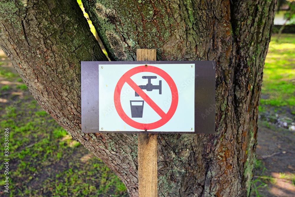 Sign Do not drink water. Crossed by red line black glass and water tap ...