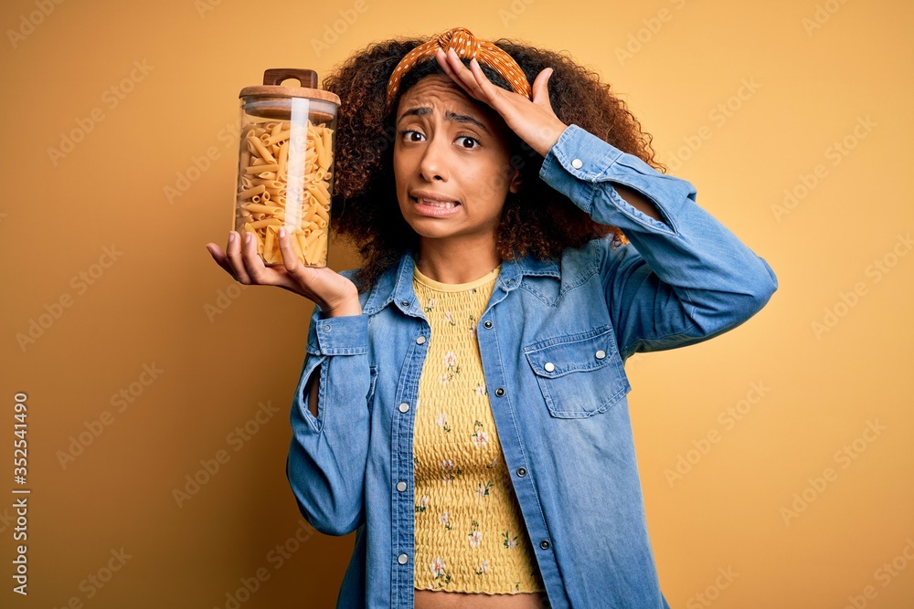 Young african american woman with afro hair holding jar with healthy ...