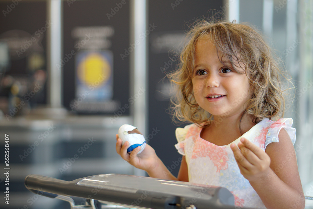 A 4 Year Old Girl Is Happy With Her Chocolate Egg In A Supermarket a-4-year-old-girl-is-happy-with-her-chocolate-egg-in-a-supermarket