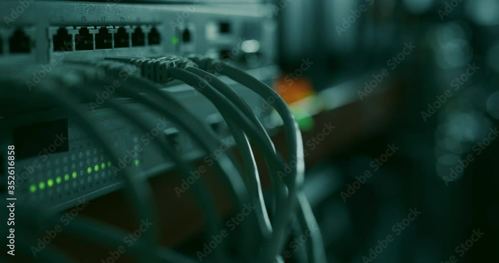 Networking hardware with attached RJ45 ethernet cables working in a ...