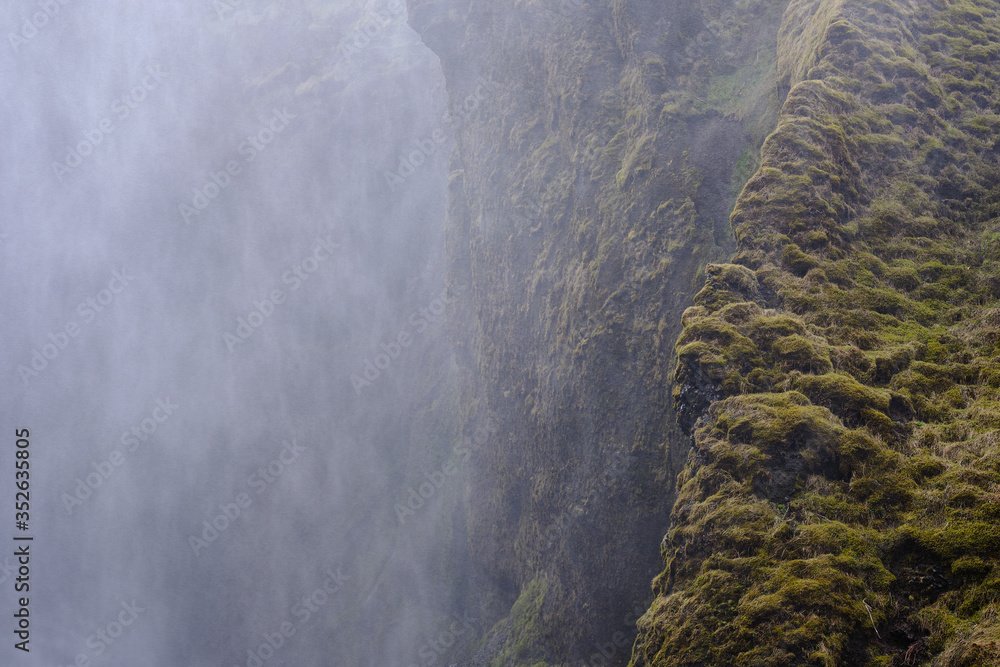 spray and mist from Skogafoss Icelandic waterfall helps the moss and ...