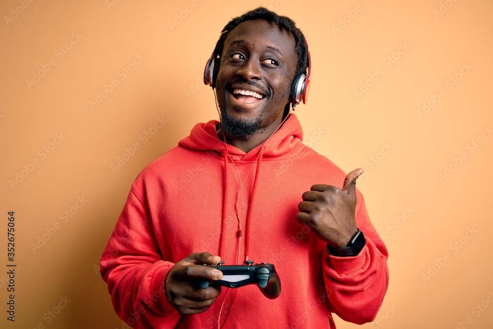 Young african american gamer man playing video game using joystick and ...