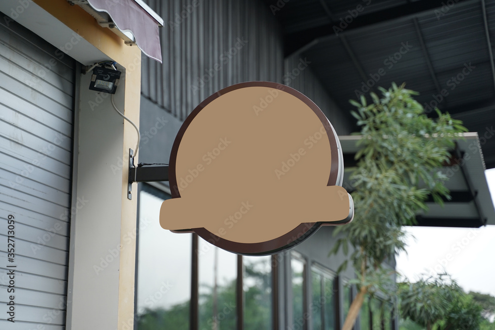 The circular billboard hangs on the front wall of the shop. Used to ...