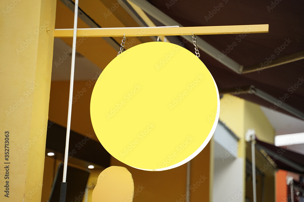 The circular billboard hangs on the front wall of the shop. Used to ...