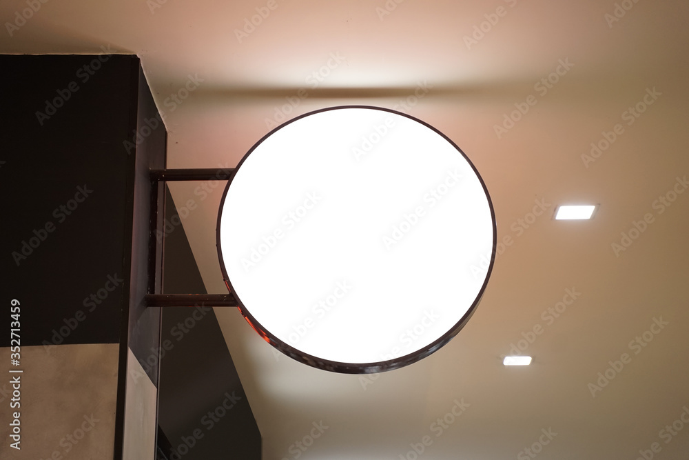The circular billboard hangs on the shop wall in the mall. Used to ...