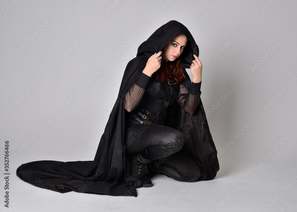 Fantasy portrait of a woman with red hair wearing dark leather assassin ...