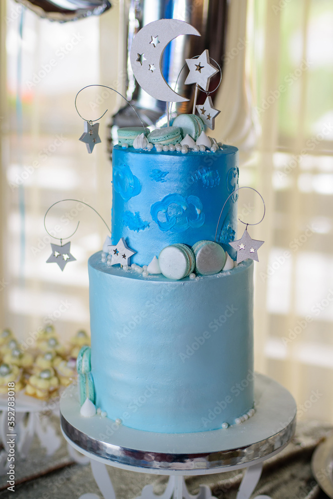 Blue birthday cake with macarons and stars on candy bar Stock Photo ...