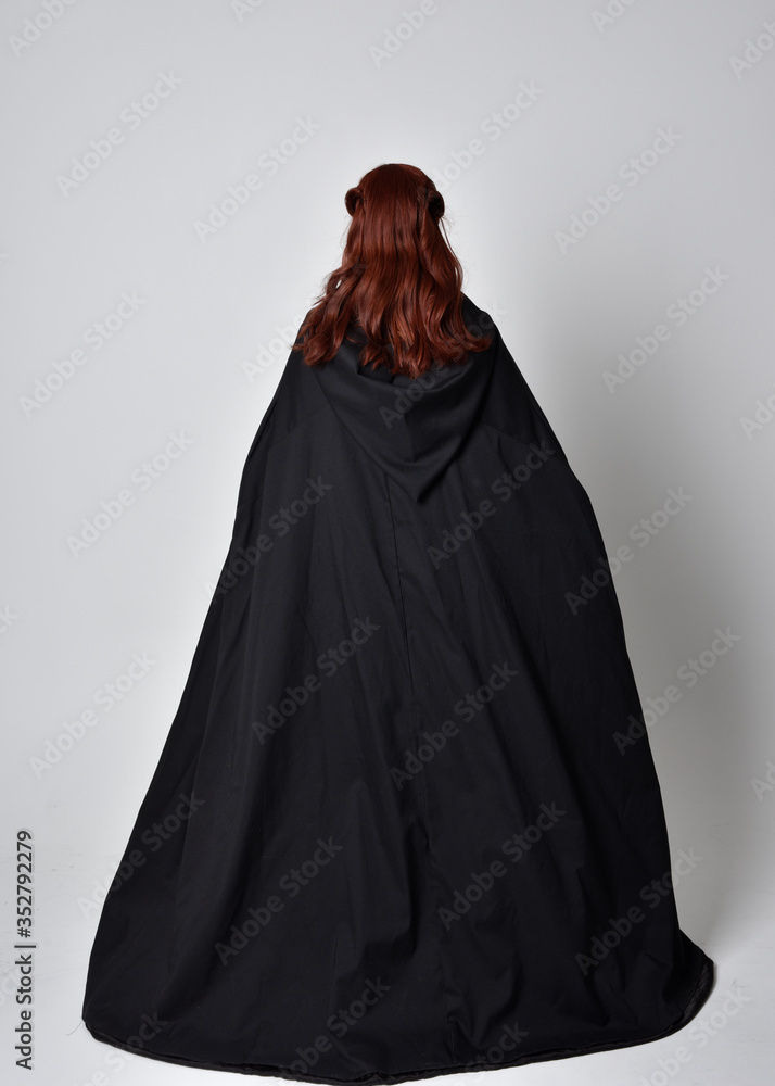 fantasy portrait of a woman wearing long black cloak. Full length ...