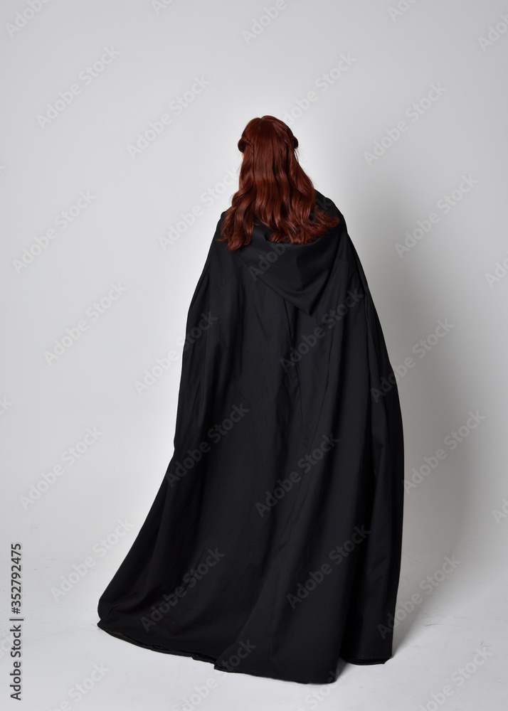 fantasy portrait of a woman wearing long black cloak. Full length ...