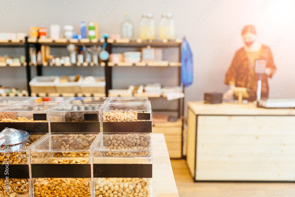 Zero waste shop interior details. Wooden shelves with different food ...
