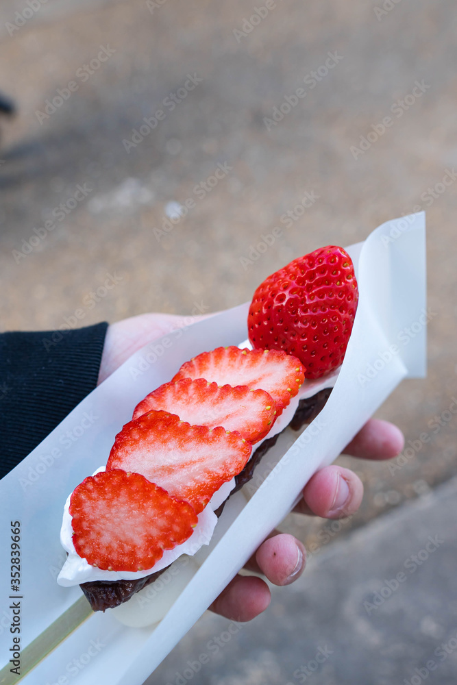 rice cake with cream and sweet red bean topped with seasoned strawberry ...