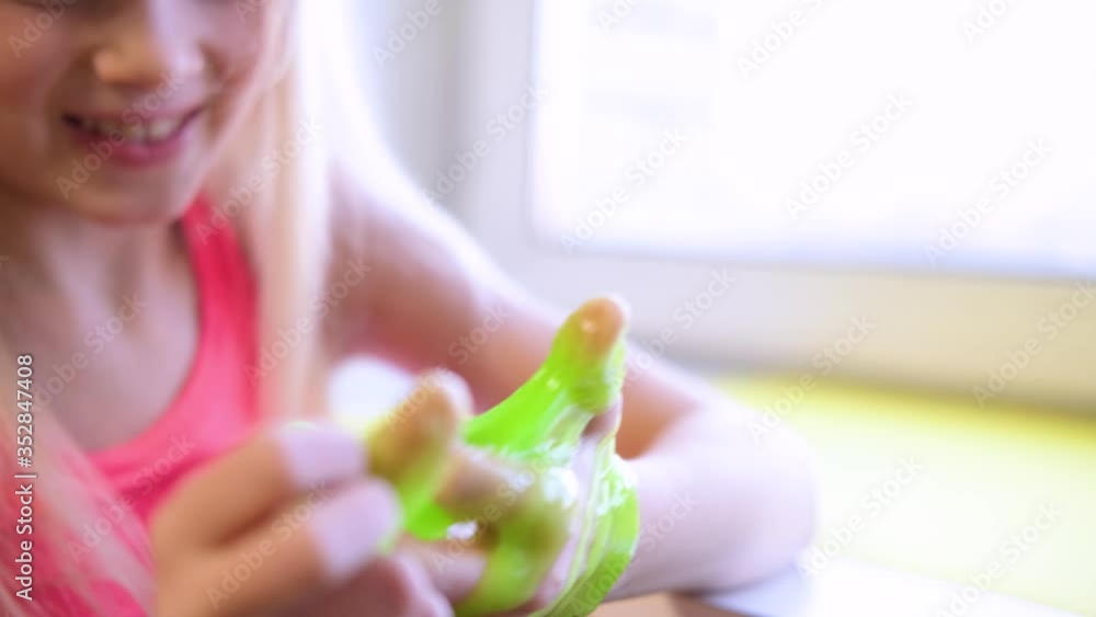 Girl Stretching Green Slime To The Sides Kids Hands Playing Slime Toy