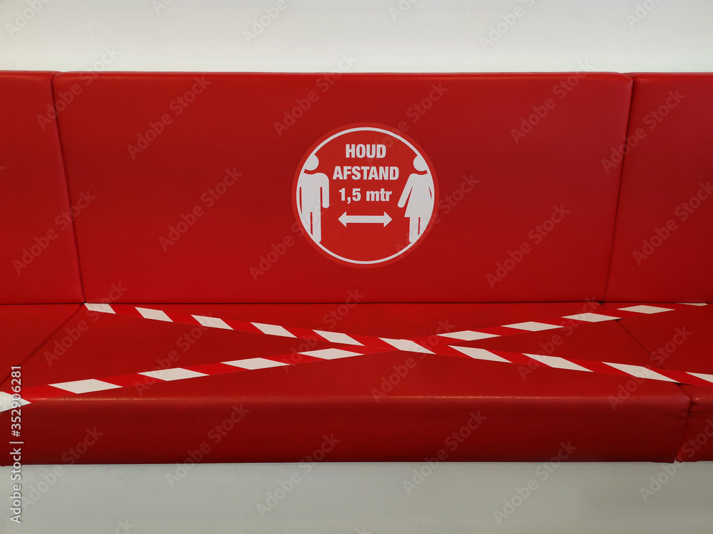 Seat in public space with social distancing sign. Translation Dutch ...
